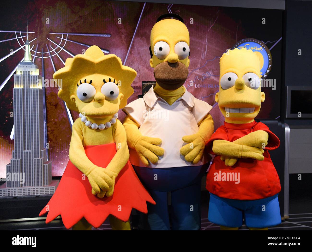 Costumed characters Lisa Simpson, left, Homer Simpson and Bart Simpson ...