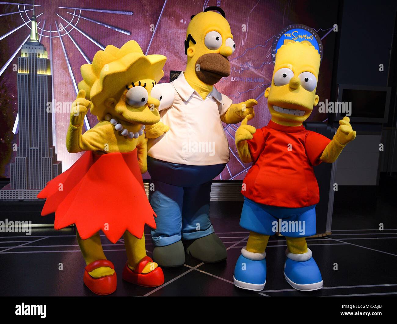 Costumed characters Lisa Simpson, left, Homer Simpson and Bart Simpson ...