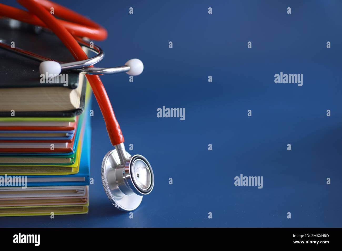 stethoscope on stack of medical guide book for doctor learning ...