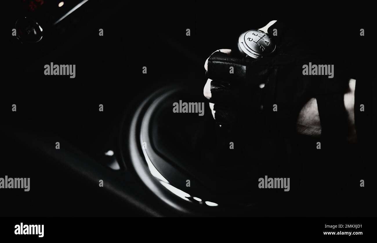 Hand on car gear knob. The driver switches the speed in the car. Hand ...