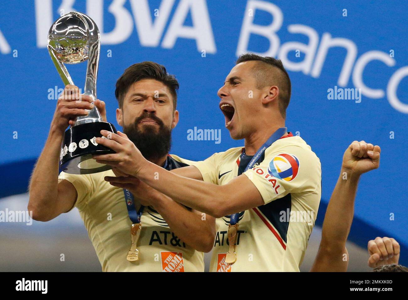 America's Paul Aguilar, right, and Uribe Peralta hold their team's ...