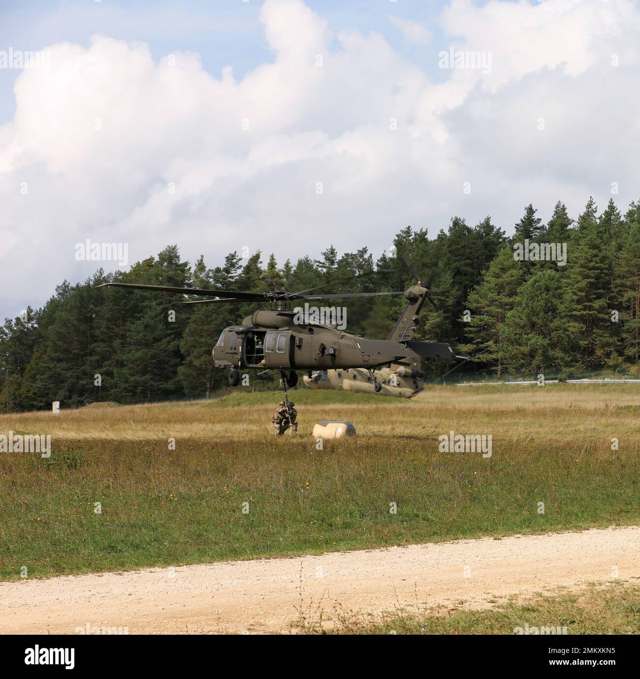 HOHENFELS, Germany – Soldiers hook a water blivet onto a UH-60 Black ...