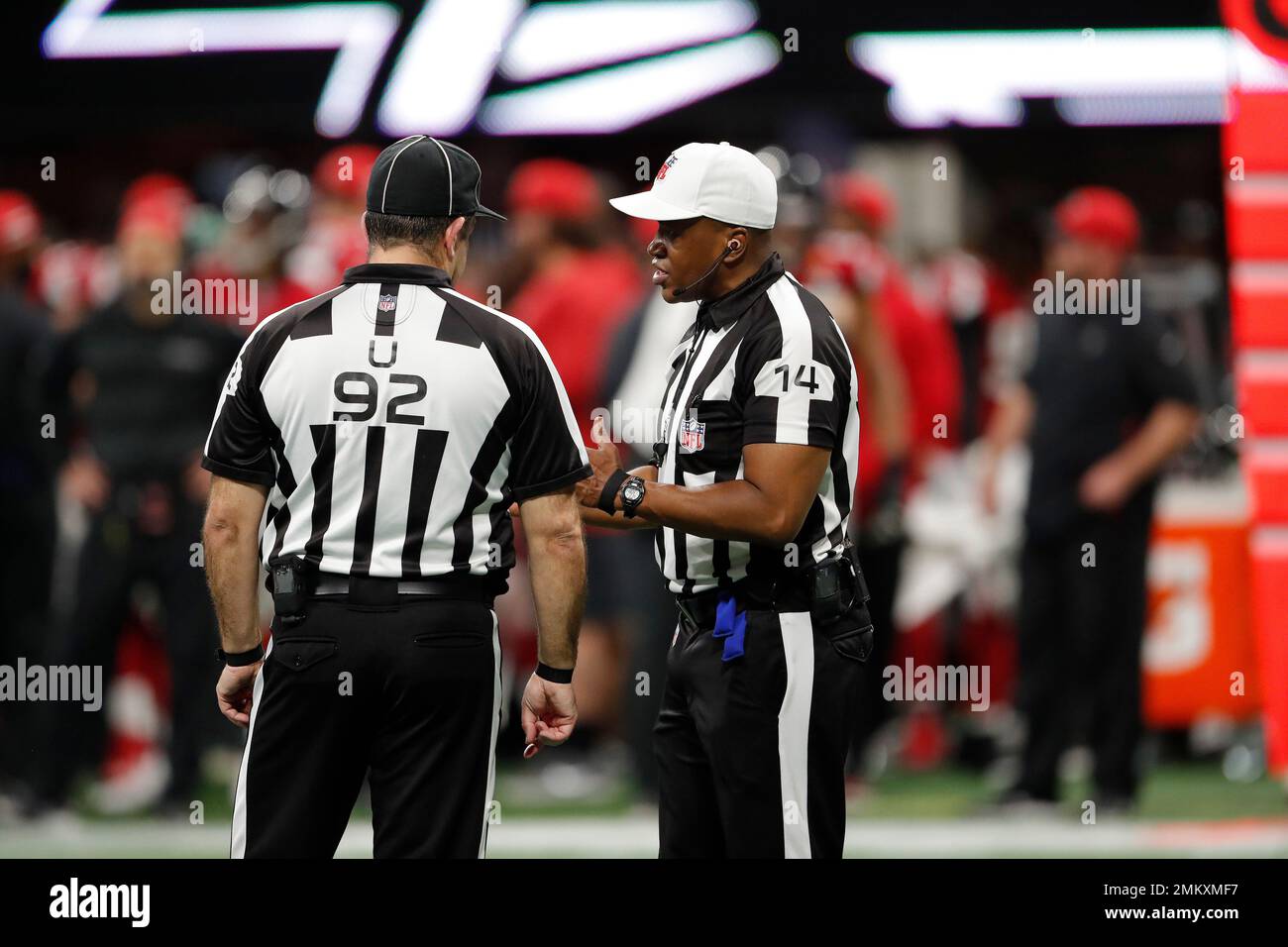 Official referee Shawn Smith (14) speaks with umpire Bryan Neale (92 ...