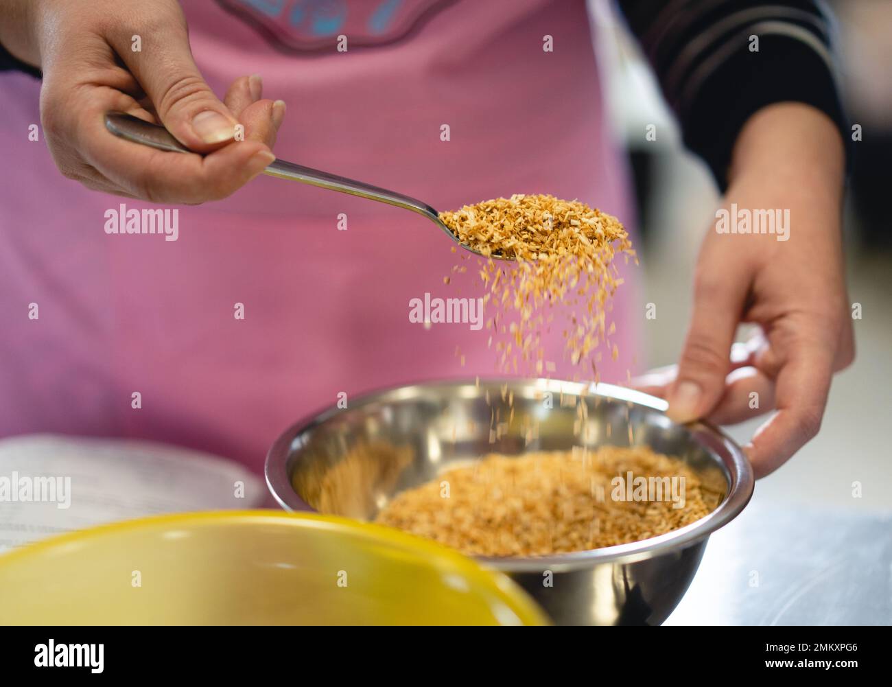 the cook sprinkles spoonfuls of spices in the kitchen Stock Photo - Alamy