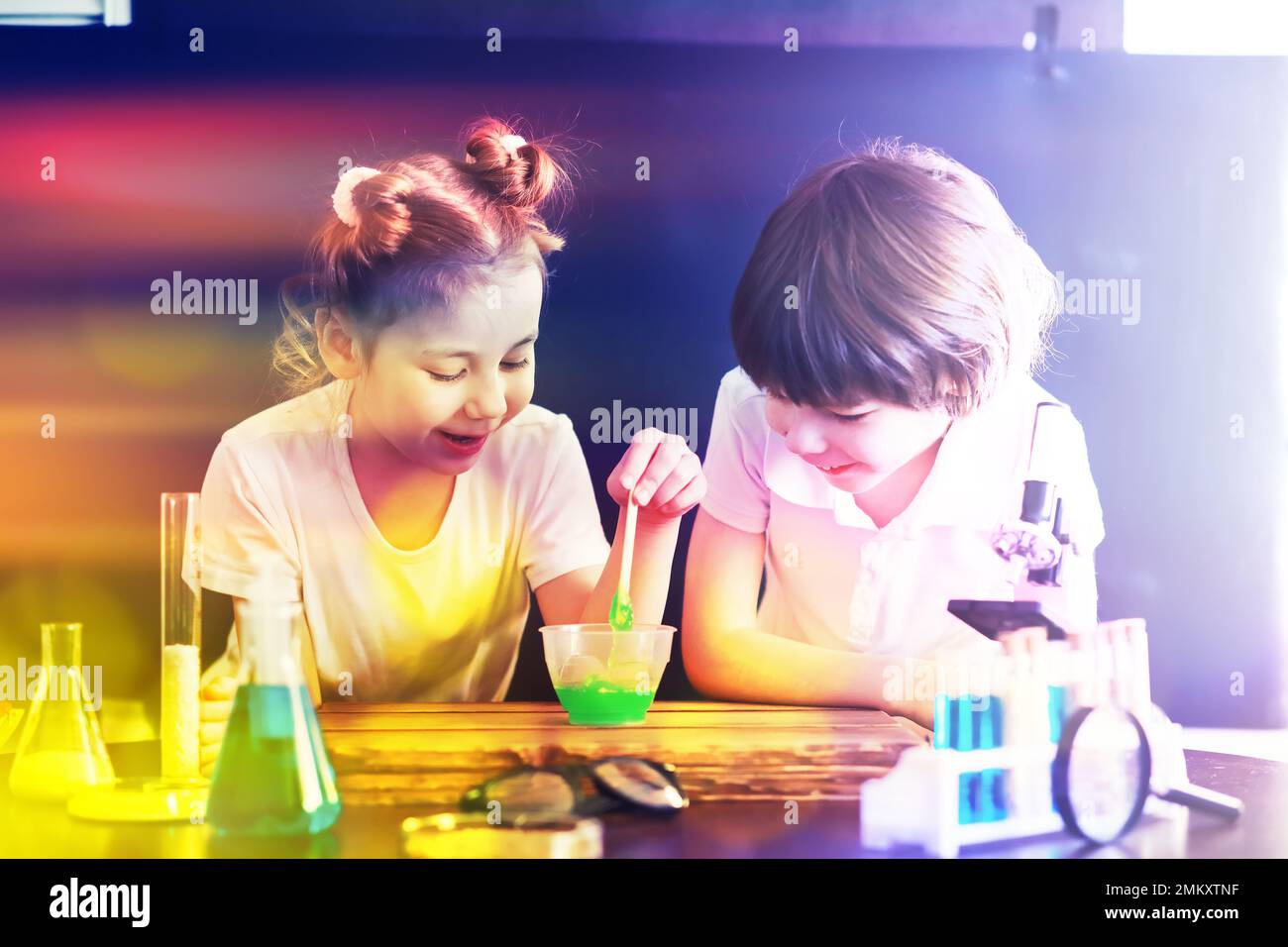 Children scientists. Schoolchildren in laboratory conduct experiments ...