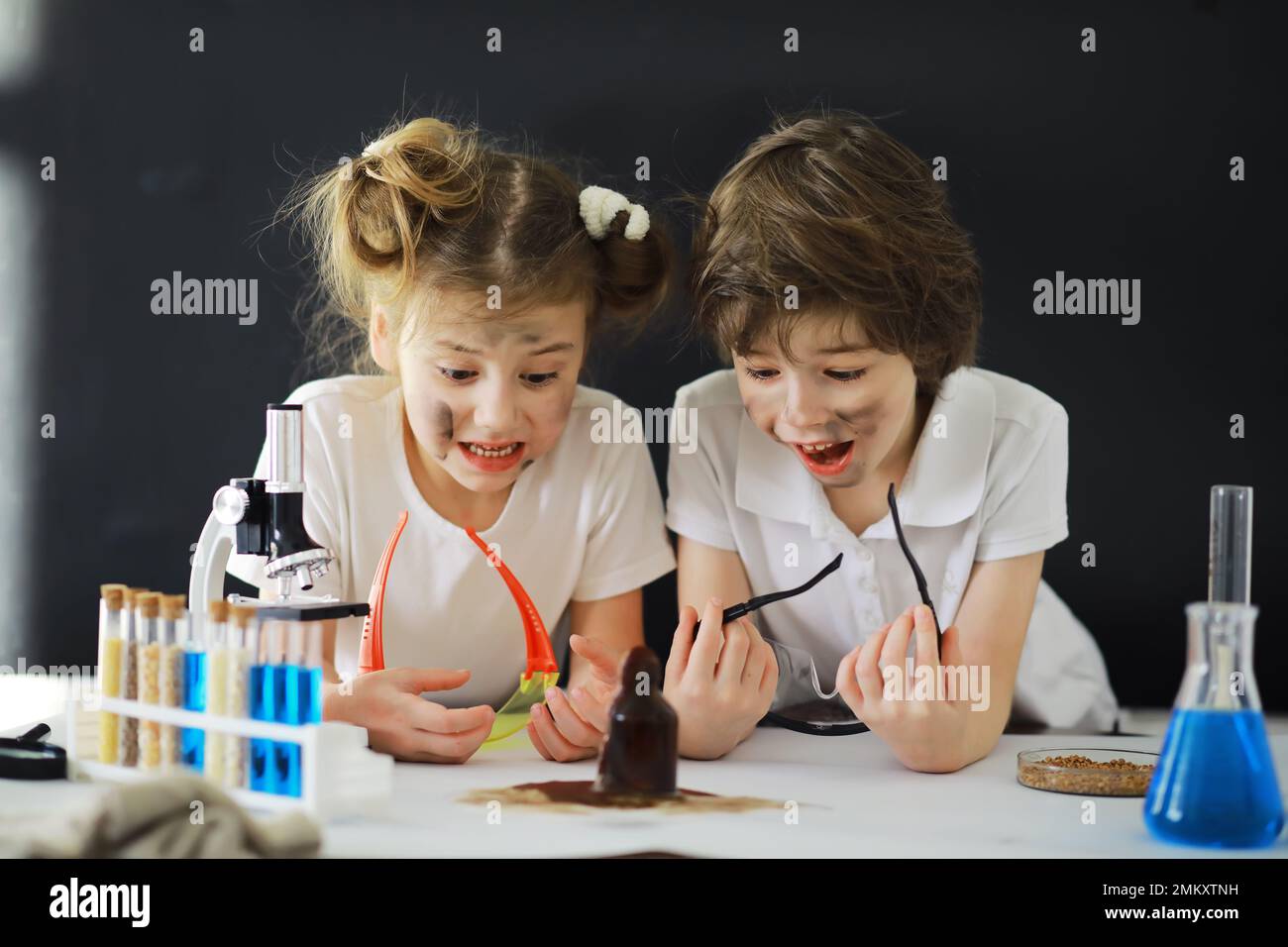 Children scientists. Schoolchildren in laboratory conduct experiments ...