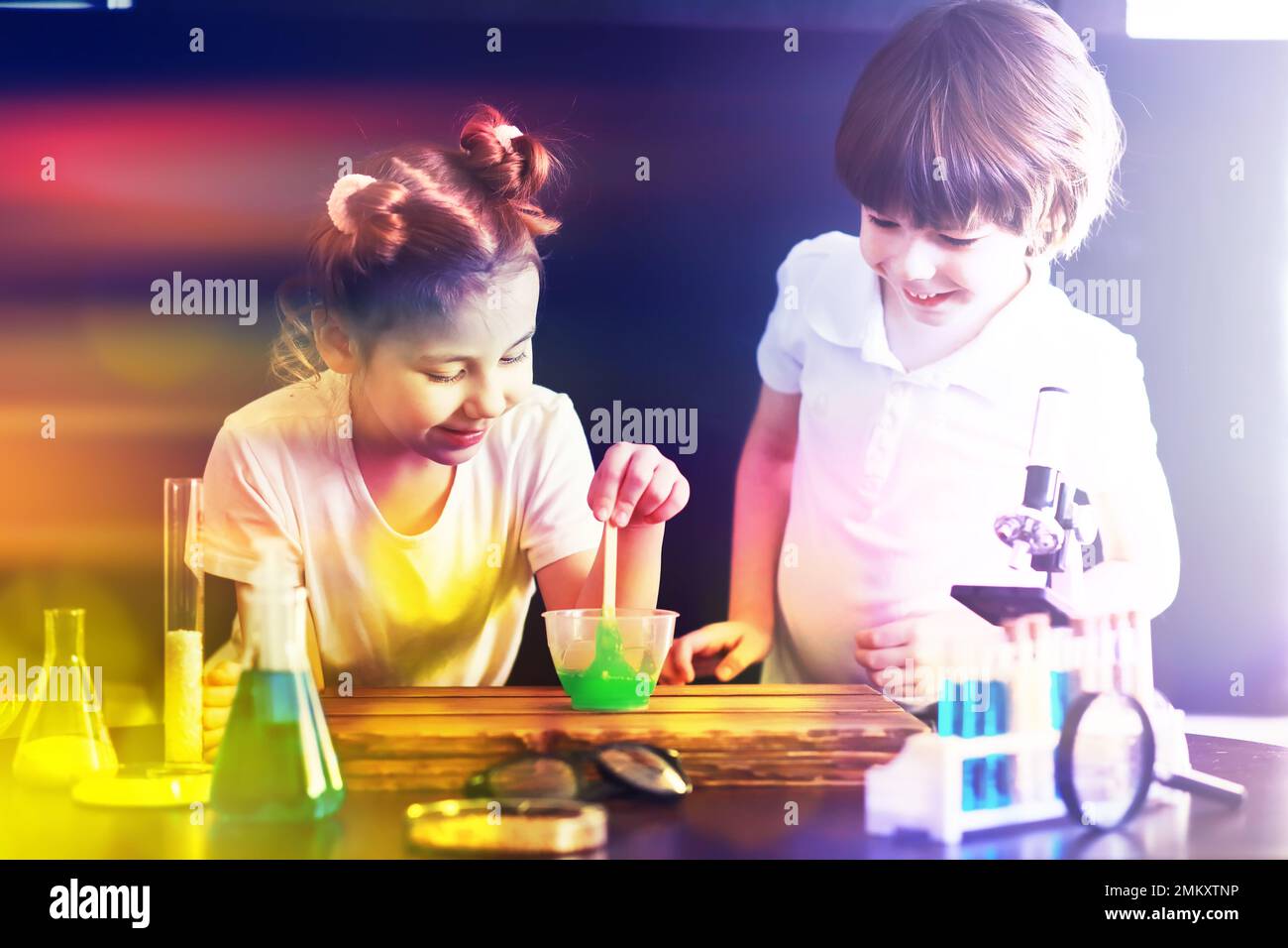Children scientists. Schoolchildren in laboratory conduct experiments ...