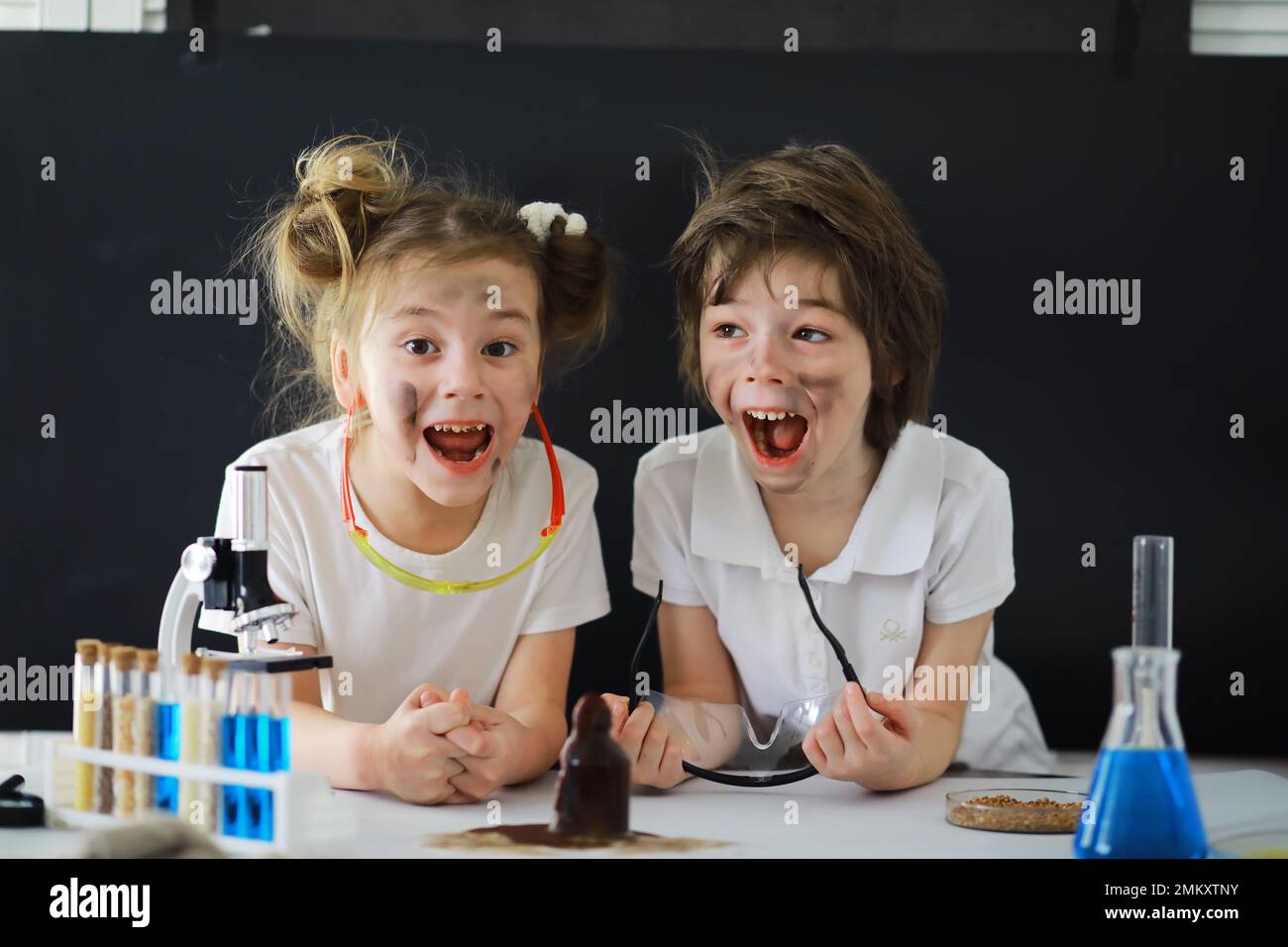Children scientists. Schoolchildren in laboratory conduct experiments ...