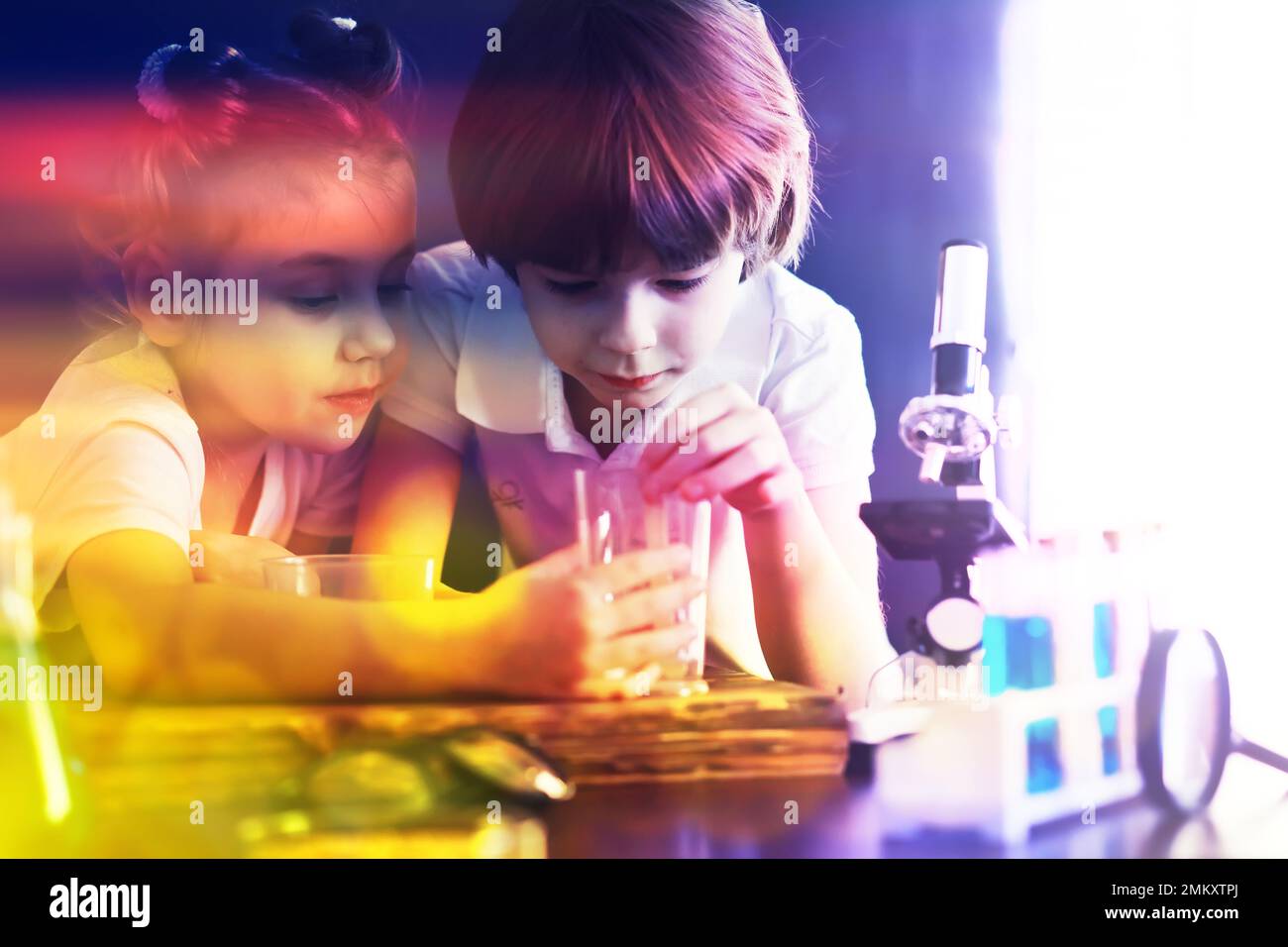 Children scientists. Schoolchildren in laboratory conduct experiments ...