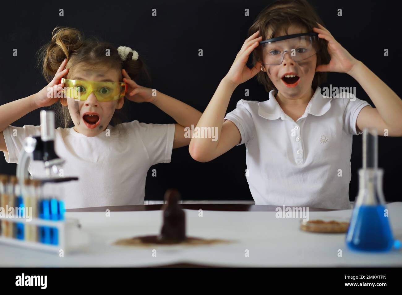 Children scientists. Schoolchildren in laboratory conduct experiments ...