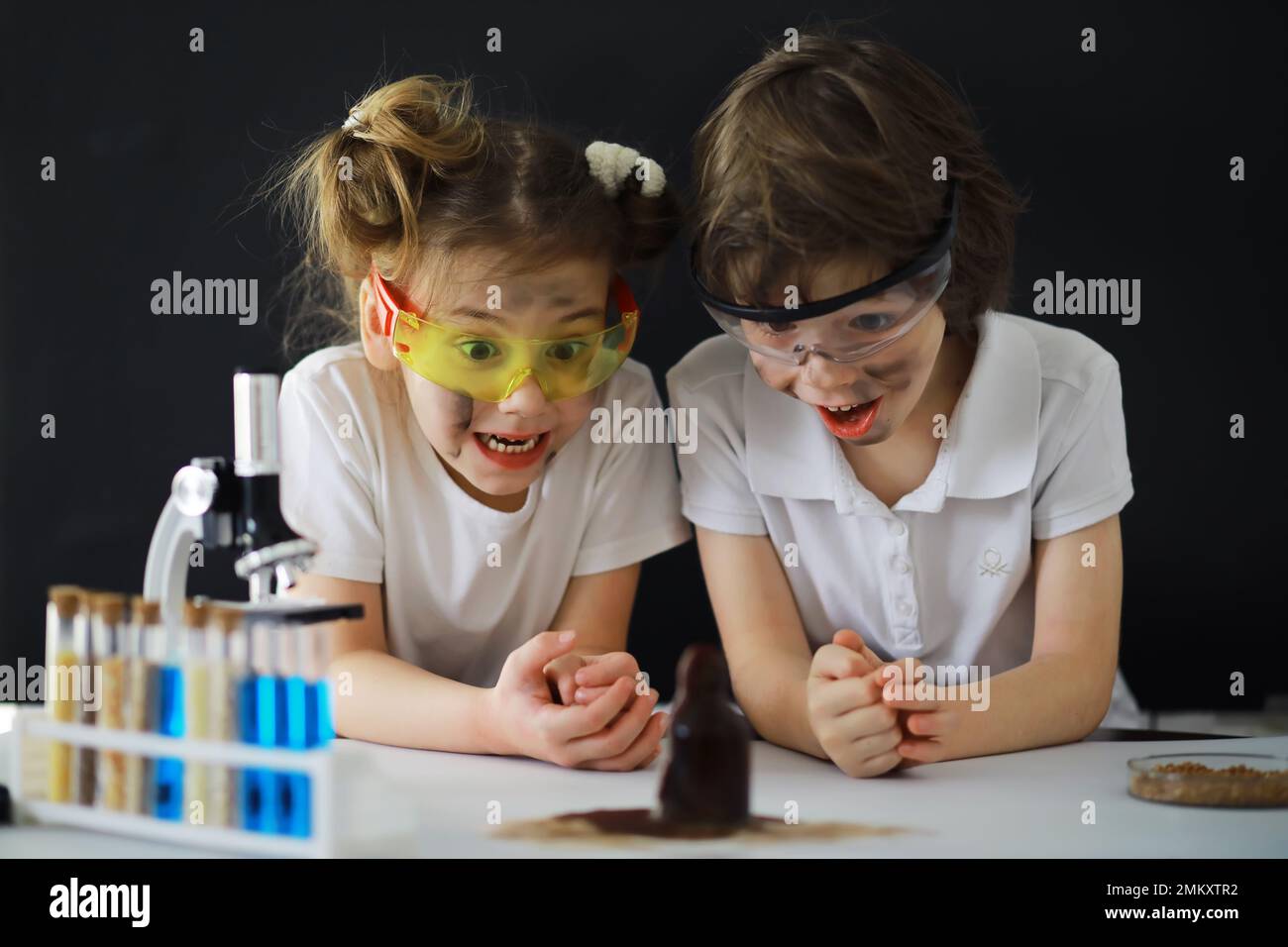 Children scientists. Schoolchildren in laboratory conduct experiments ...