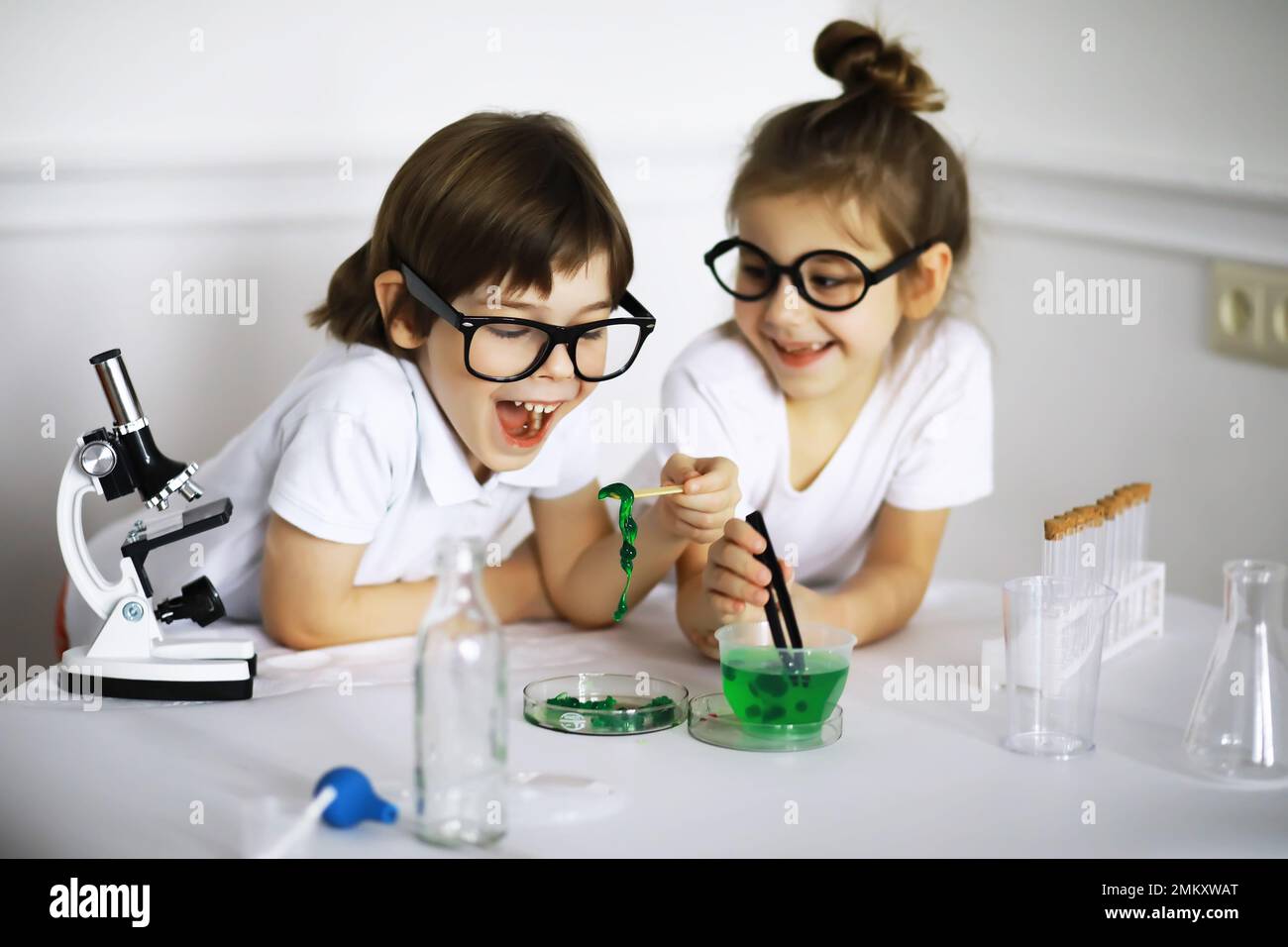 Two cute children at chemistry lesson making experiments isolated on ...