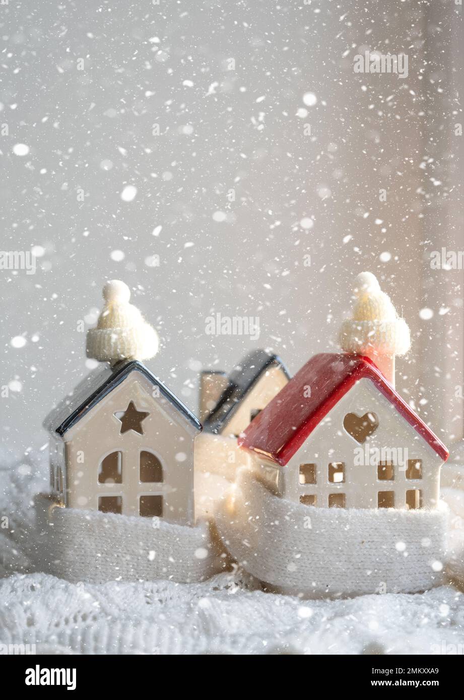 Cozy house is wrapped in a hat and scarf in a snowstorm -window sill ...