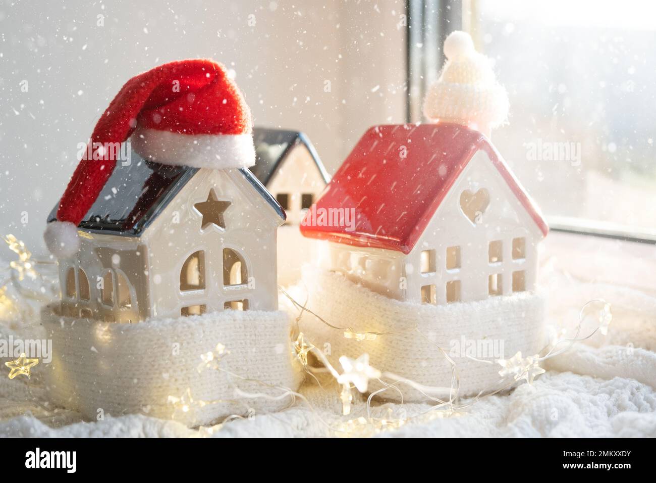 Cozy house is wrapped in a hat and scarf in a snowstorm -window sill ...