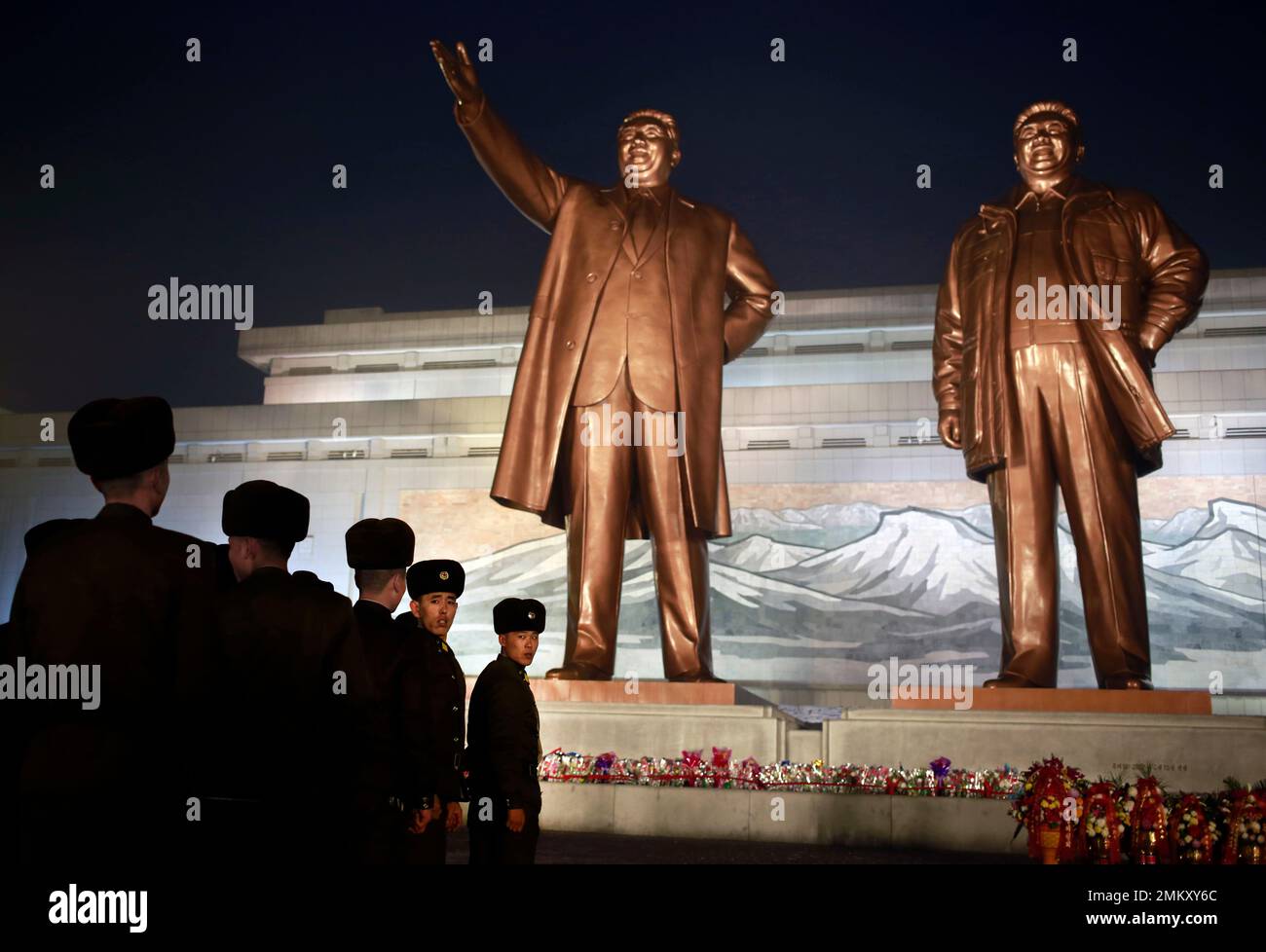 North Korean soldiers line up as they pay respect to the bronze statues ...