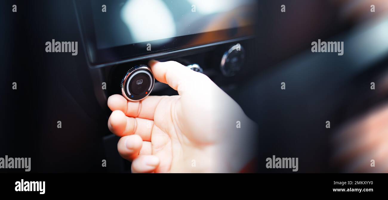 The process of choosing climate control in the car. Man regulating ...