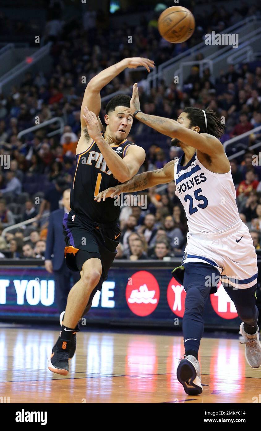 Phoenix Suns guard Devin Booker (1) makes a no-look pass over the ...