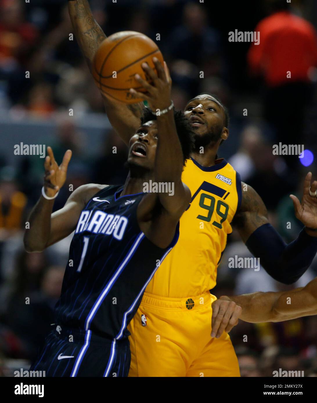 Orlando Magic's Jonathan Isaac, left, shoots against Utah Jazz's Jae ...