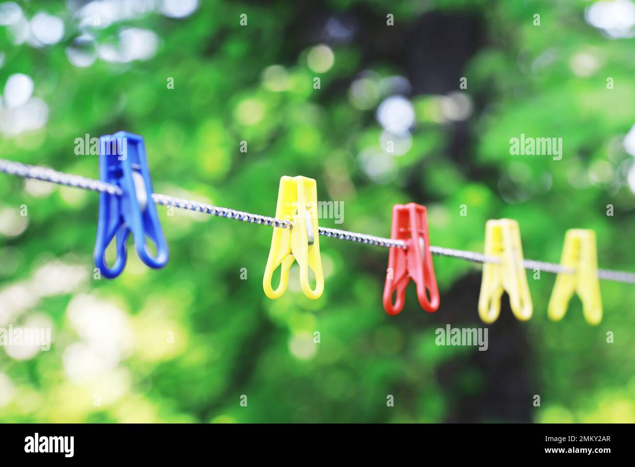Clothespins on a clothesline in summer. Dry clothes outside. Clothes on ...