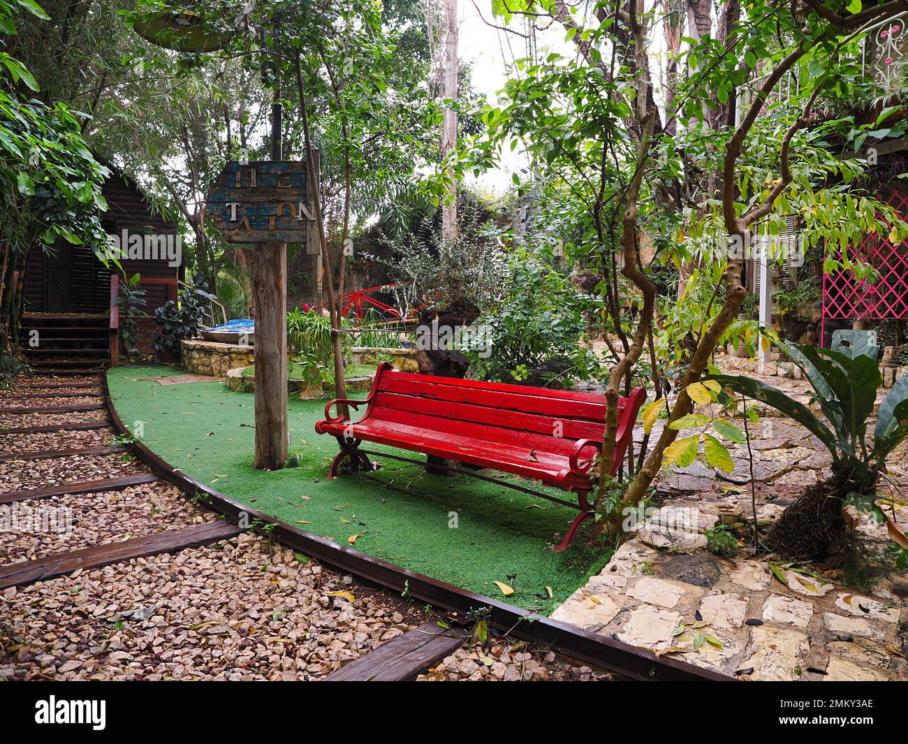 Red vintage bench and decorative rails in Al Muna park. Druze village ...