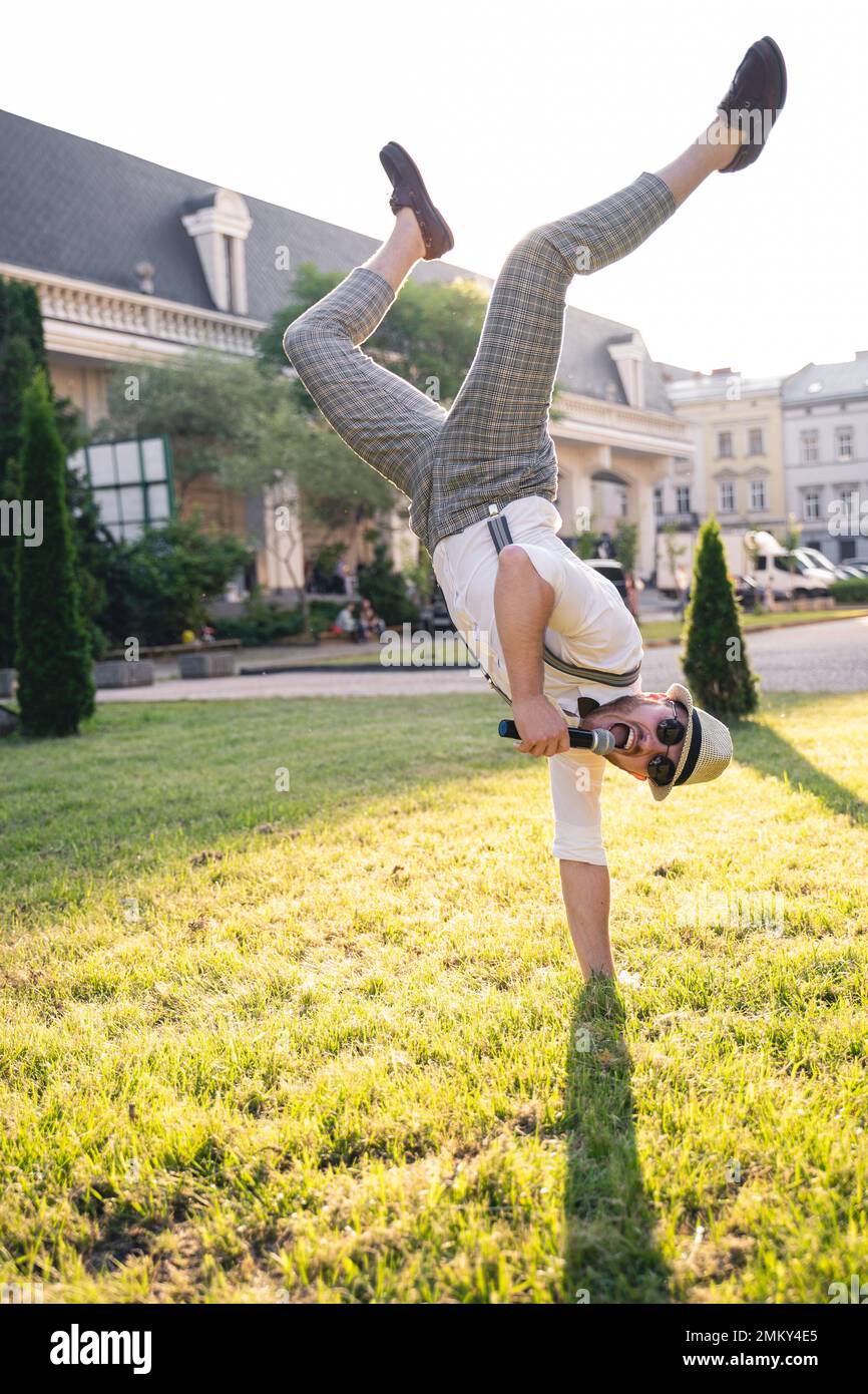 handsome presenter and showman in a stylish suit and hat with a ...