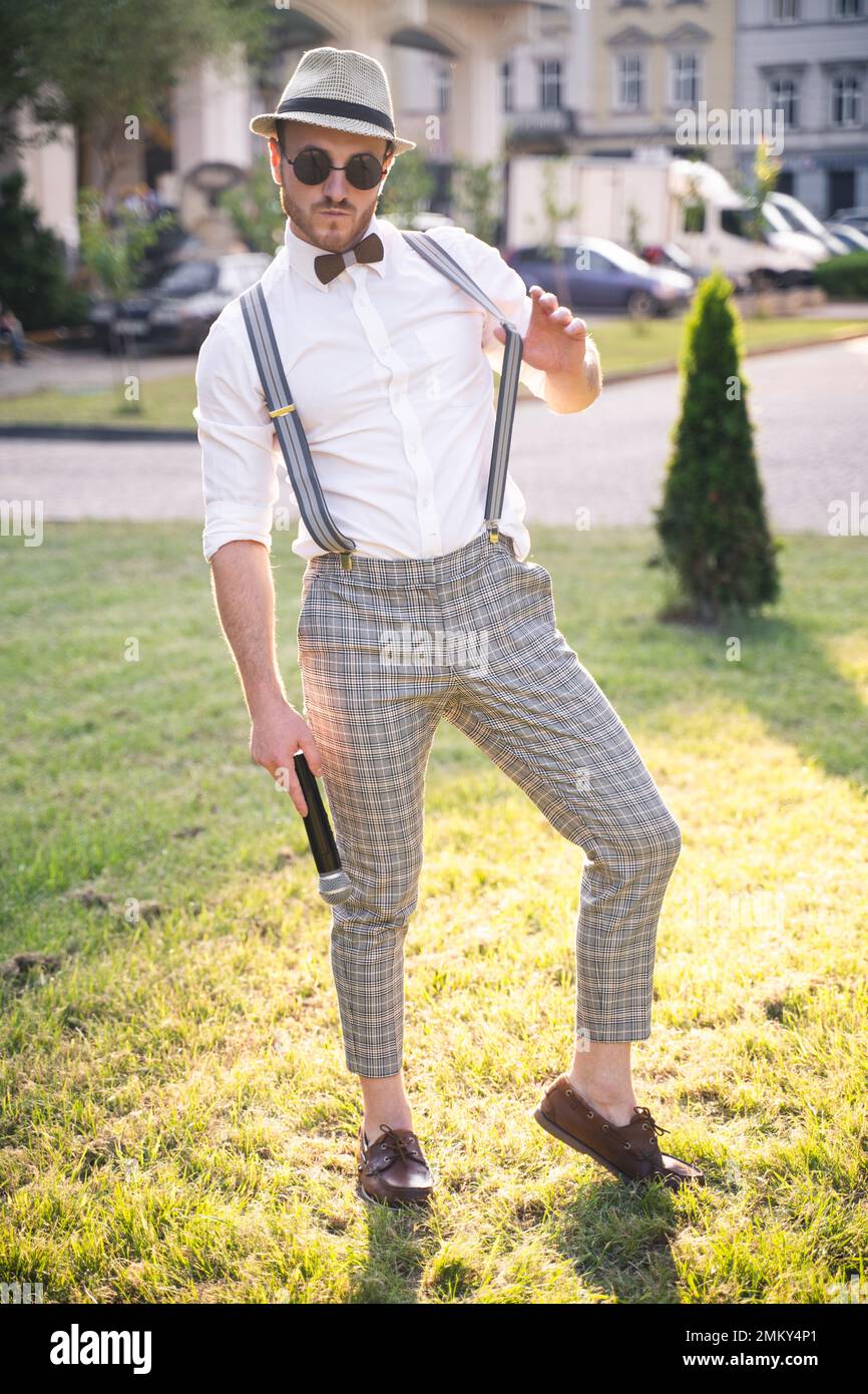 handsome presenter and showman in a stylish suit and hat with a ...