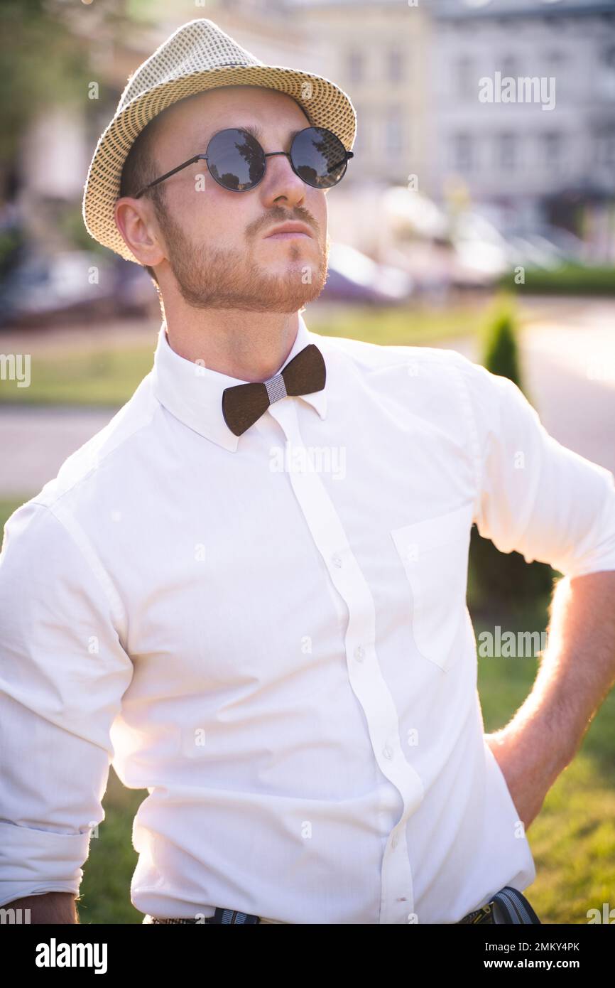 handsome presenter and showman in a stylish suit and hat with a ...