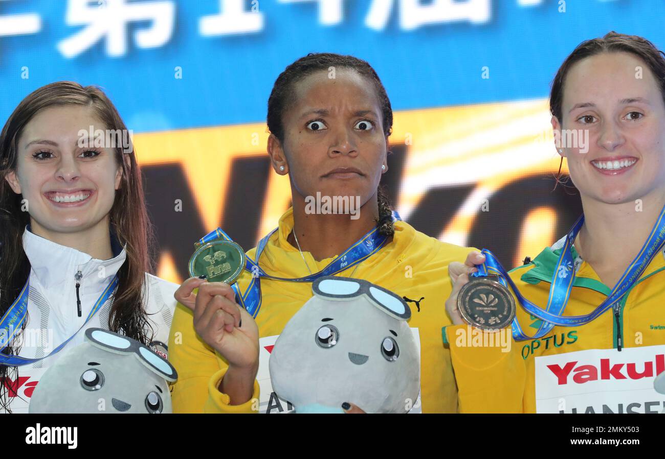 Gold medalist Jamaica's Alia Atkinson, center, gestures beside silver ...