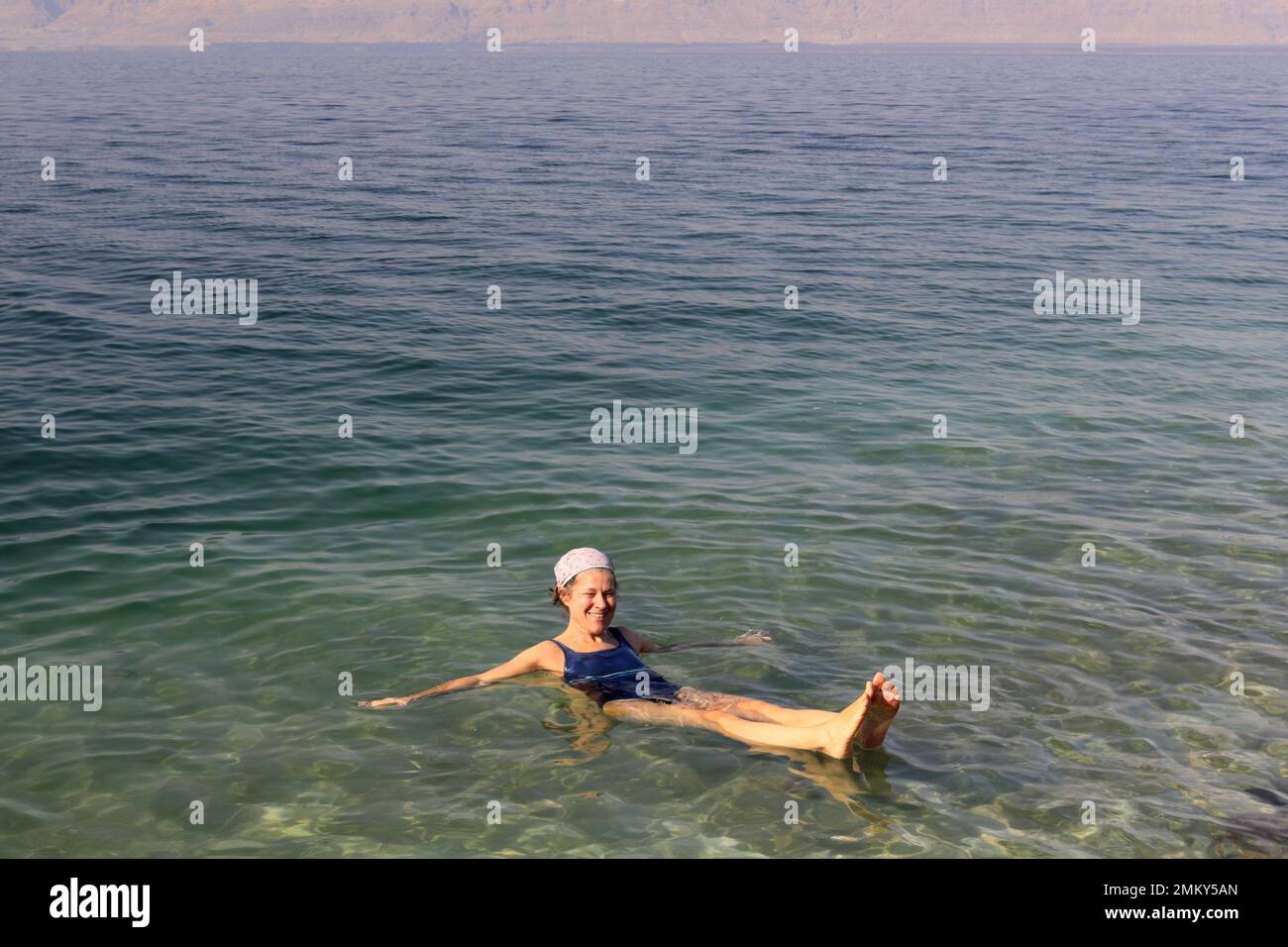 People swimming in the Dead Sea, the OH Beach hotel and resort, Jordan ...