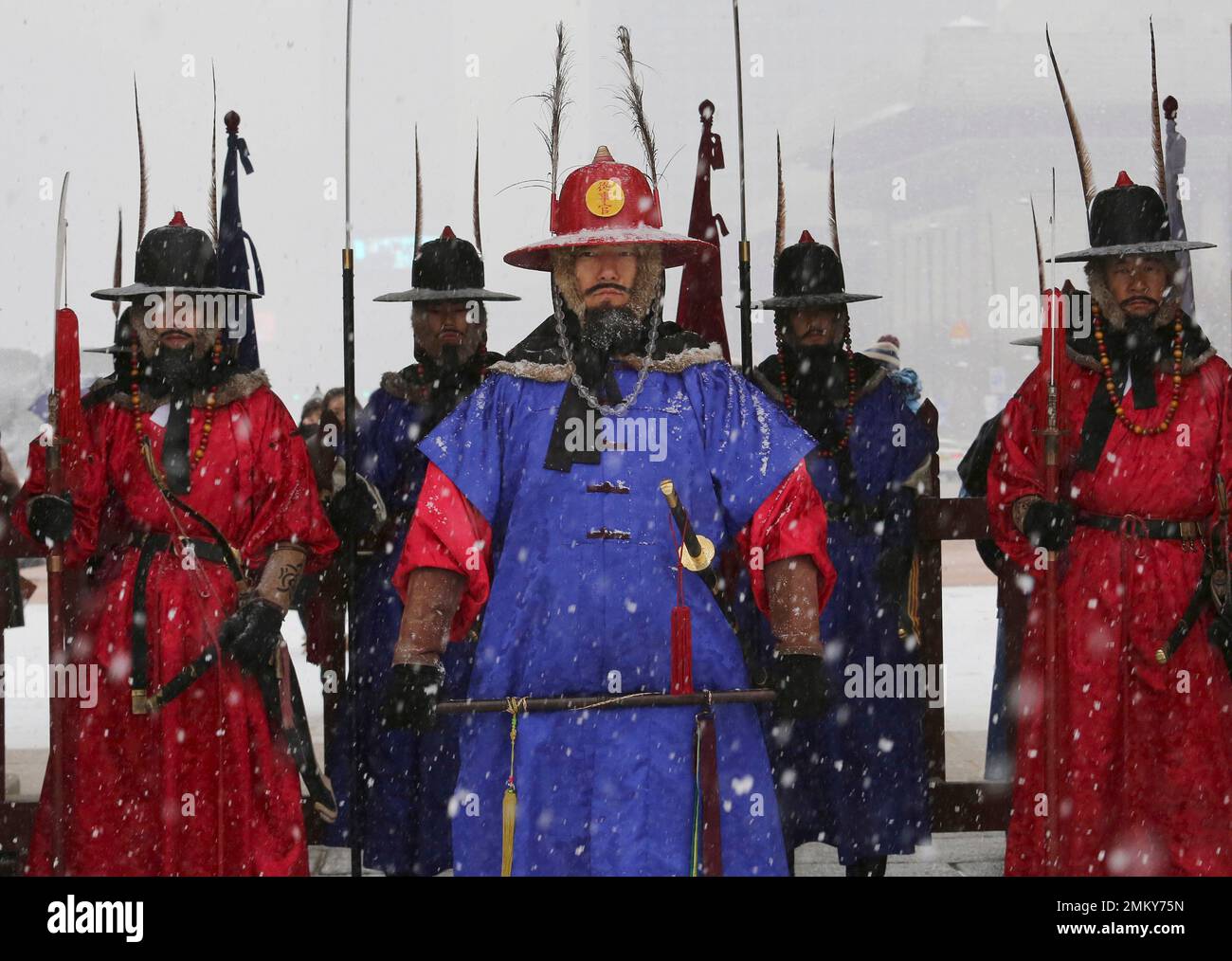 Palace guards wearing traditional military uniforms stand during ...