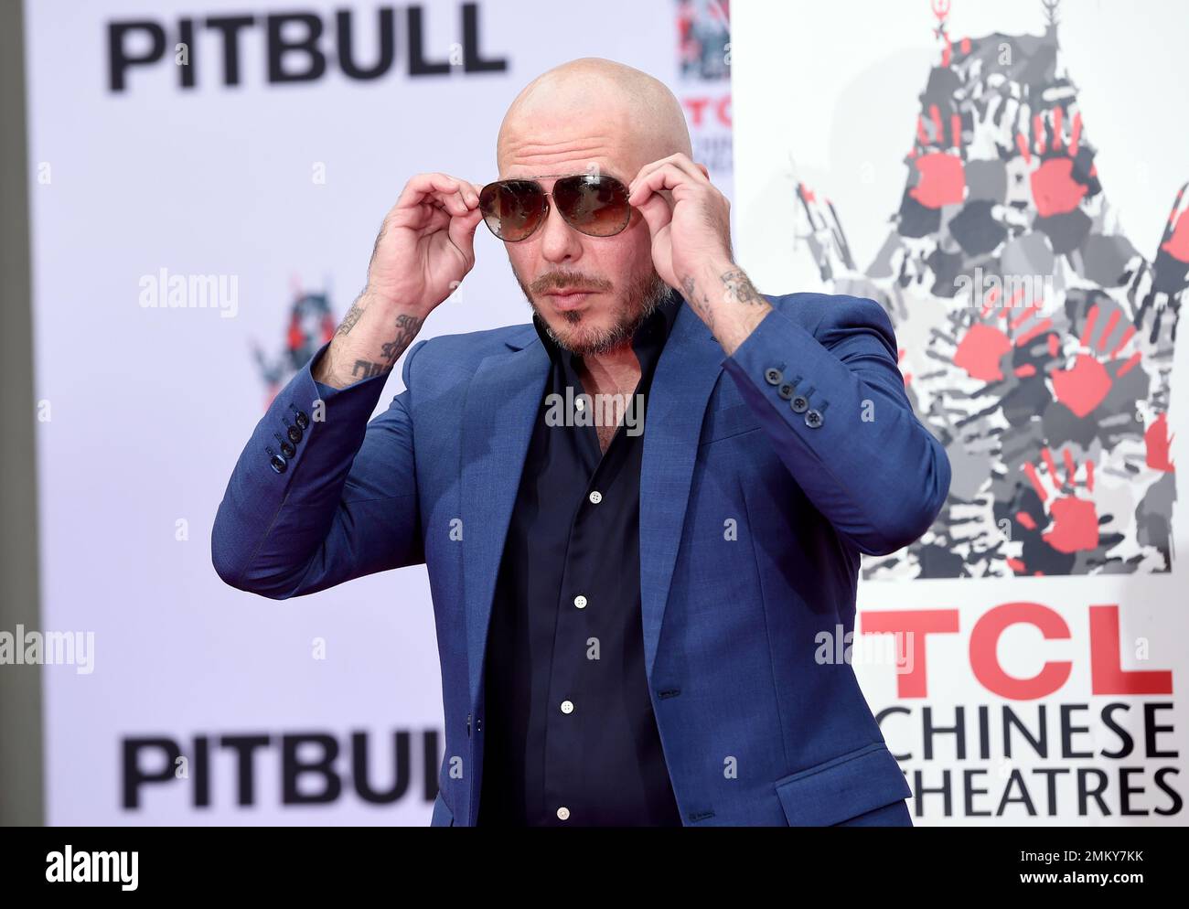 Rapper Pitbull poses during a hand and footprint ceremony in his honor ...