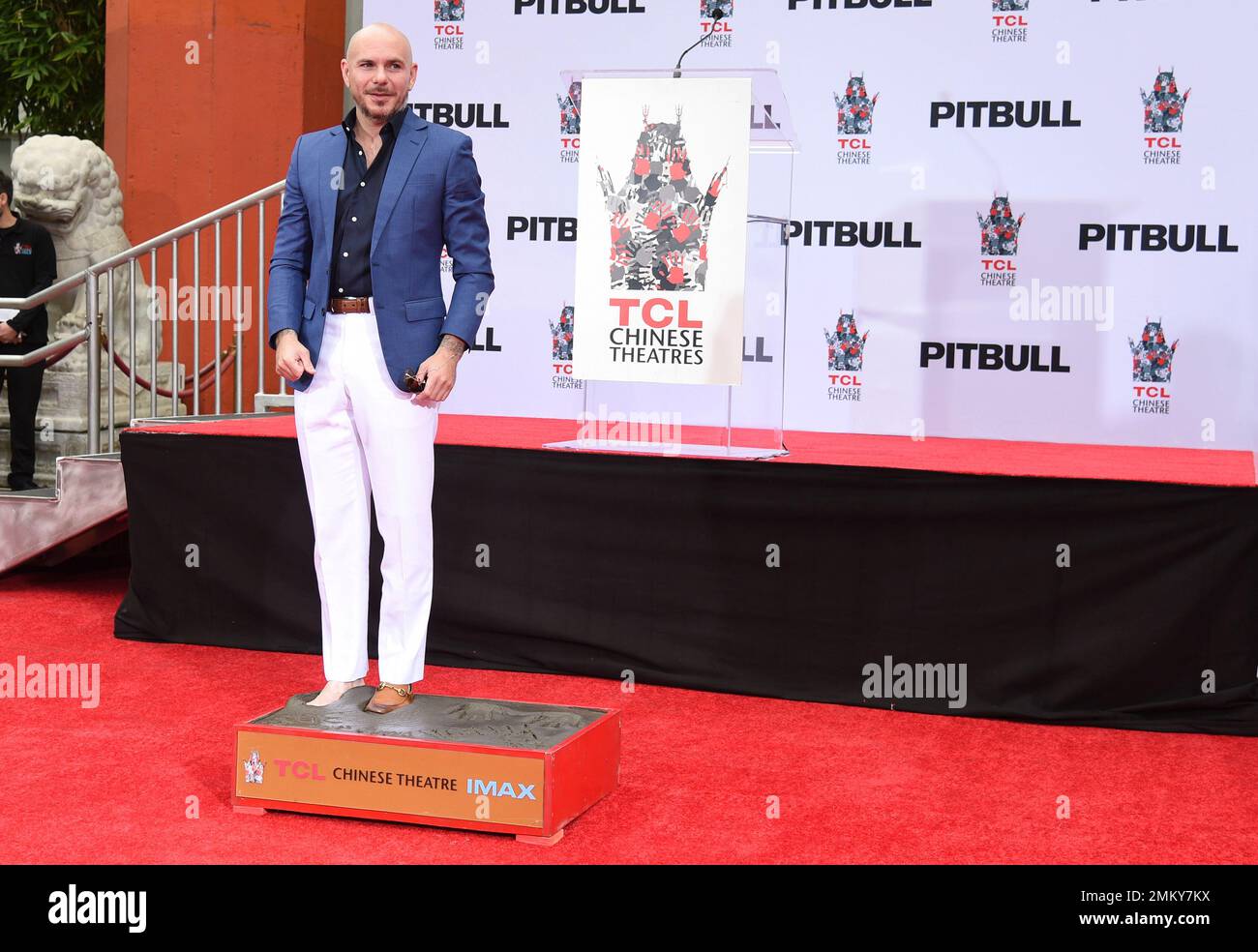 Rapper Pitbull places his feet in cement during a hand and footprint ...