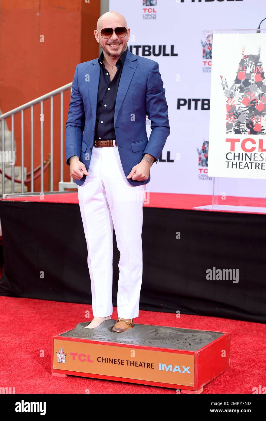 Rapper Pitbull places his feet in cement during a hand and footprint ...