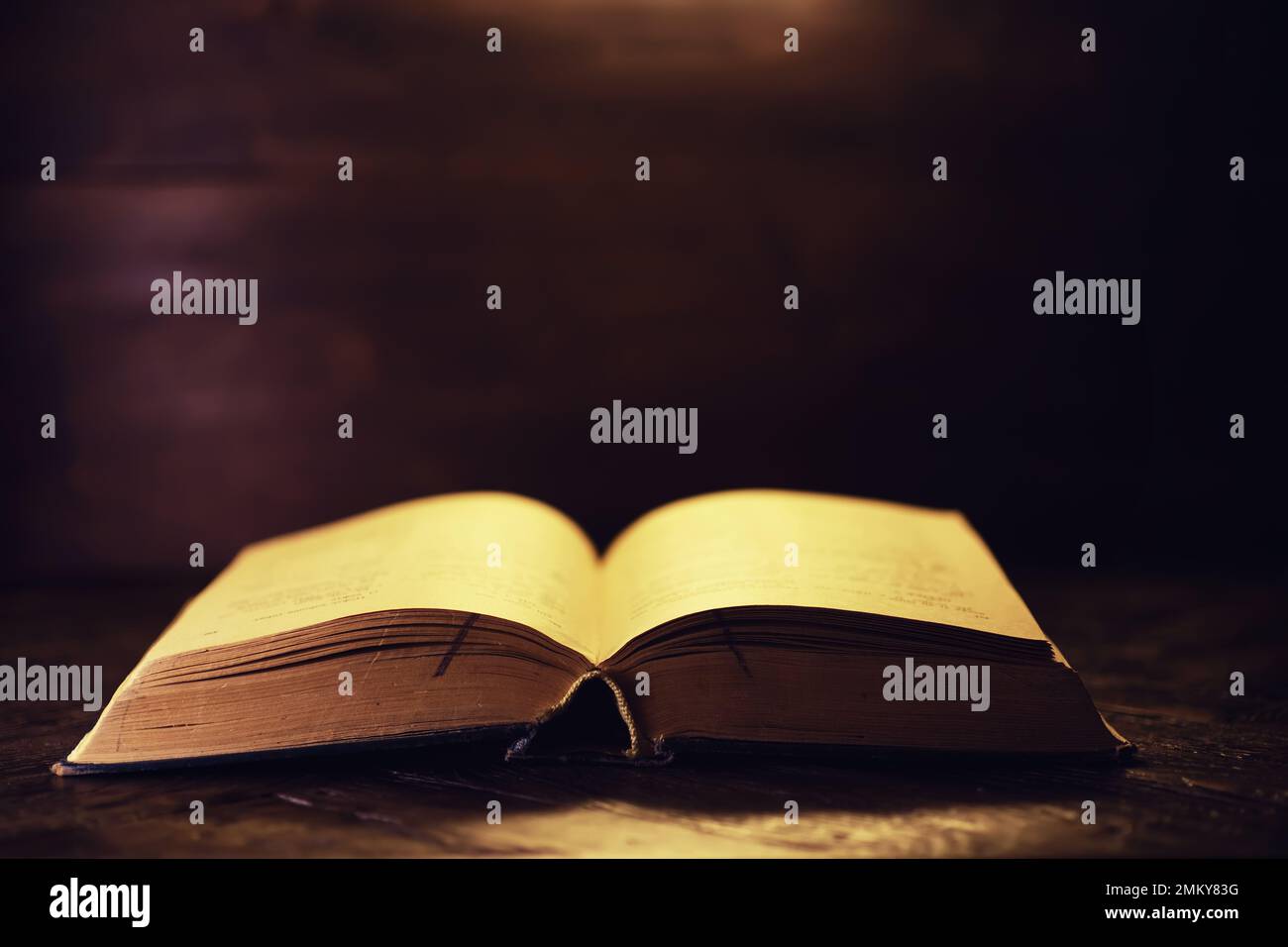 Book on a wooden table background with copy space. Historical ...