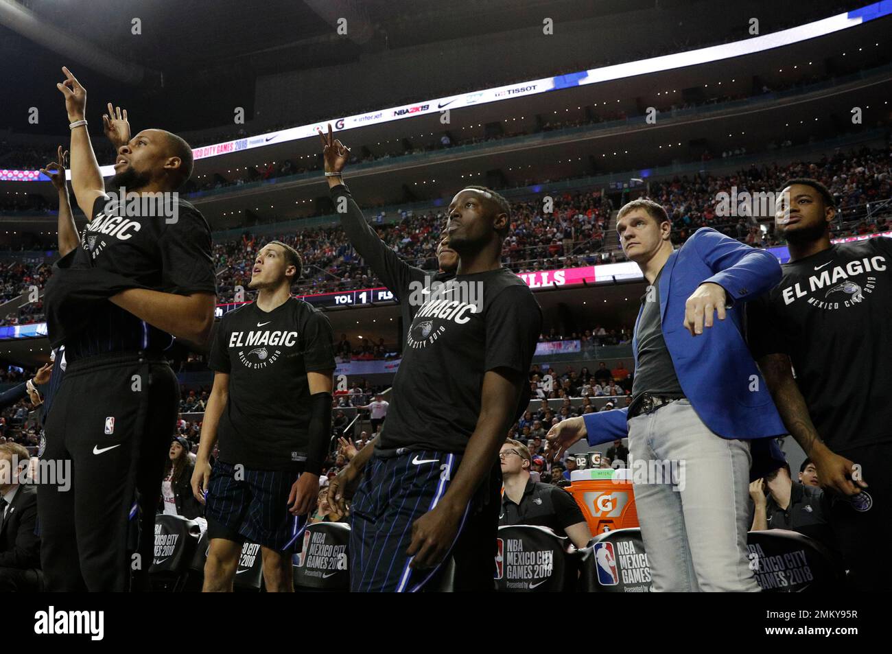 Orlando Magic players react from the bench in the tightly fought final ...