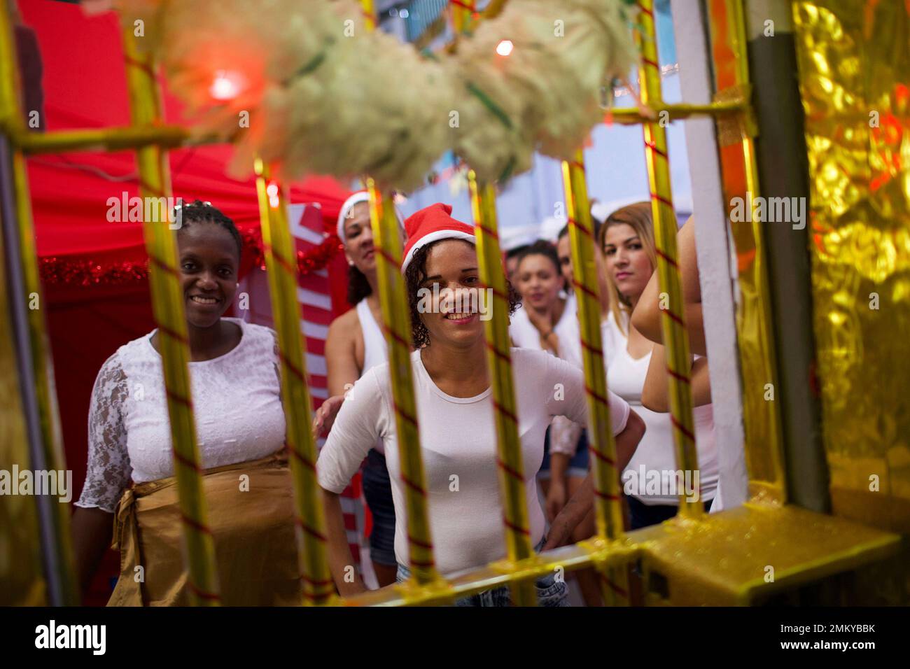 Inmates smile behind prison bars covered in decorative paper, part of a ...