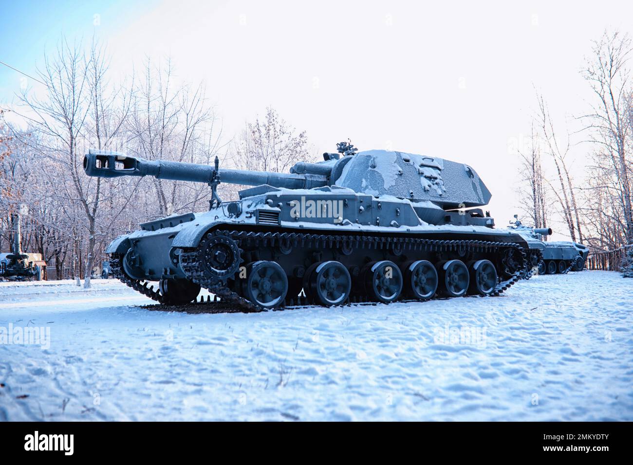 Military tank in a row. Battle tank in the snow on the roadside of ...