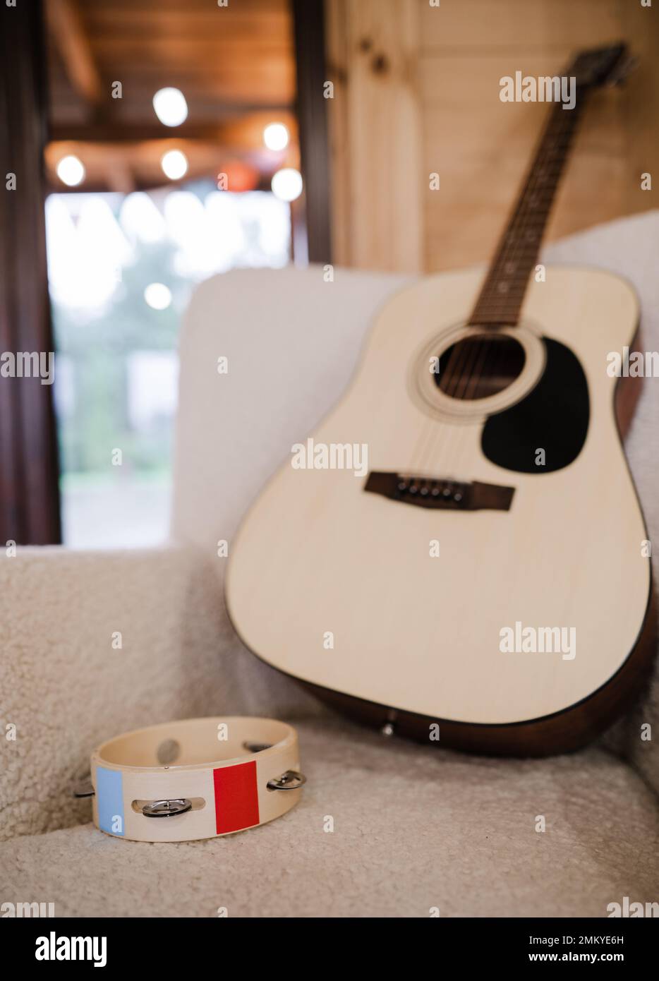musical instruments, tambourine and acoustic guitar on a chair Stock ...