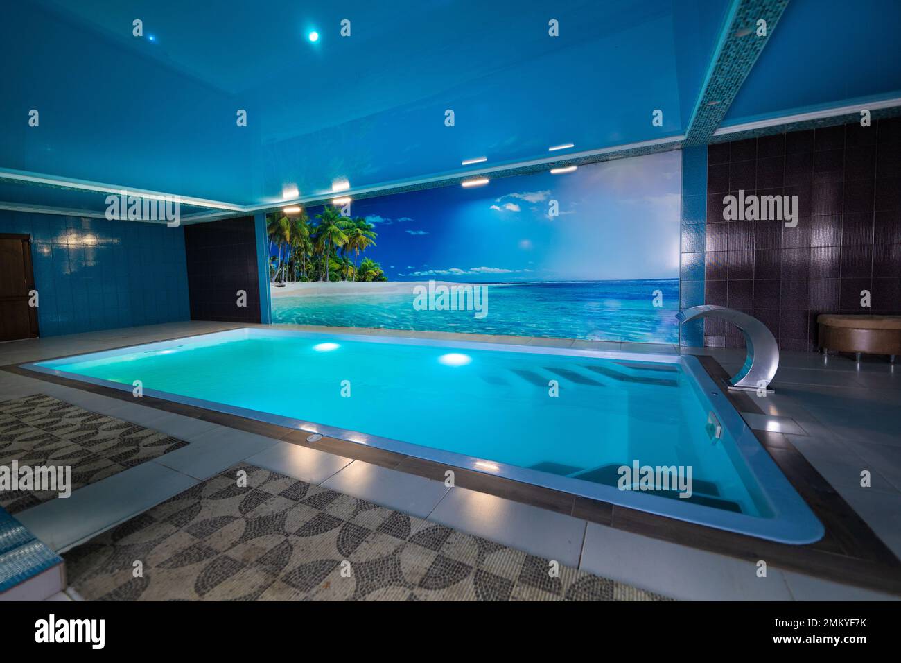 a modern large indoor pool with blue lighting and a waterfall Stock ...