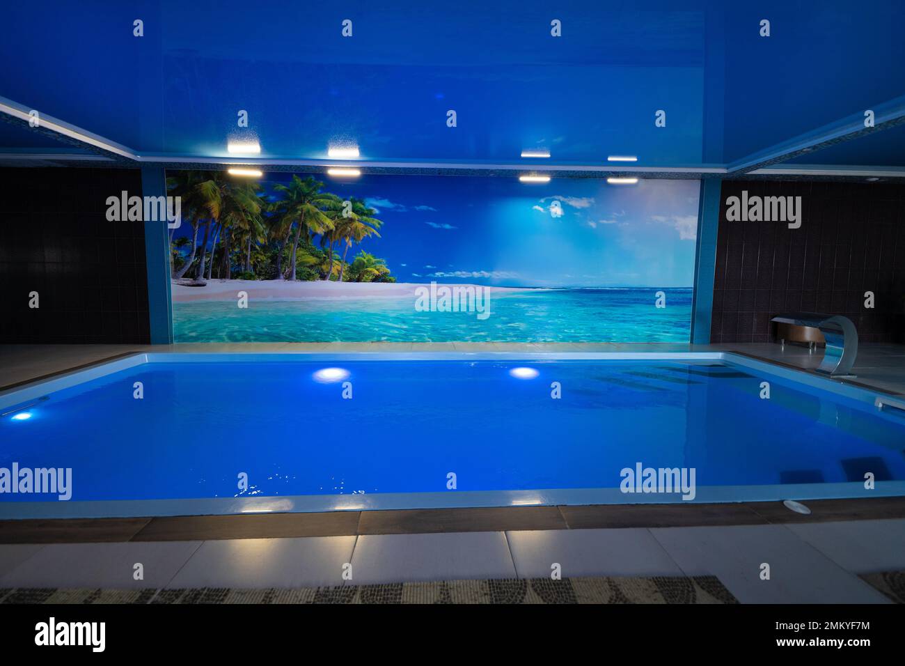 a modern large indoor pool with blue lighting and a waterfall Stock ...