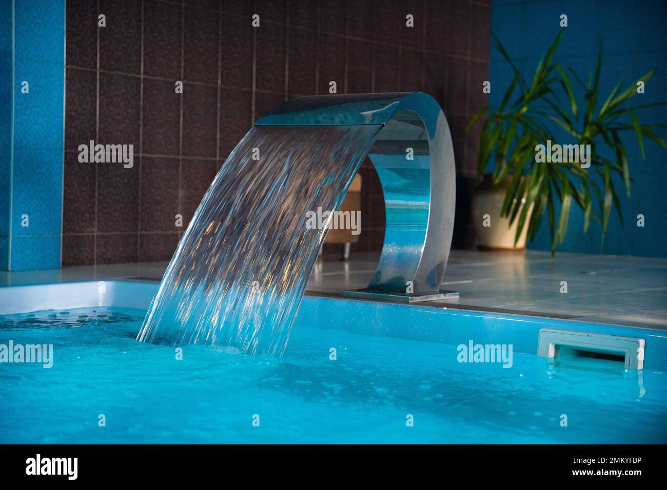 a modern large indoor pool with blue lighting and a waterfall Stock ...