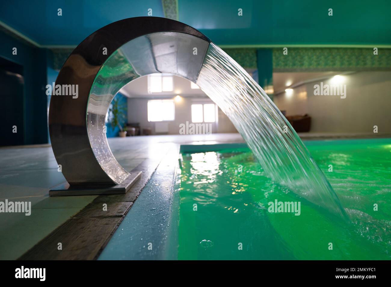 a modern large indoor pool with blue lighting and a waterfall Stock ...