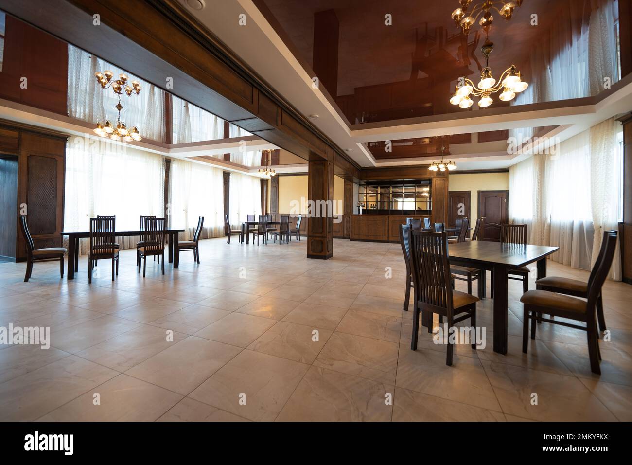 spacious interior of modern empty large restaurant with tables and ...
