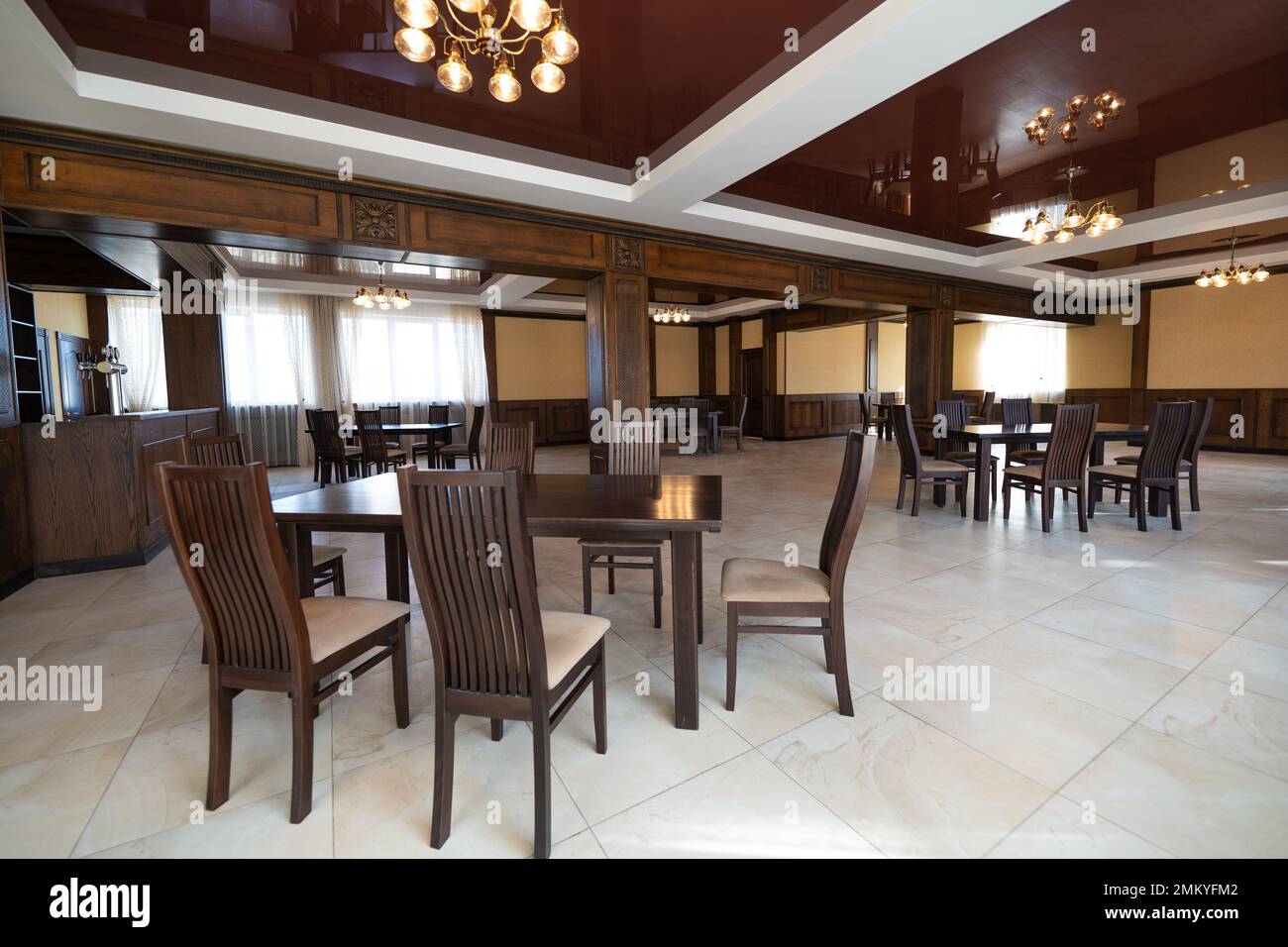 spacious interior of modern empty large restaurant with tables and ...
