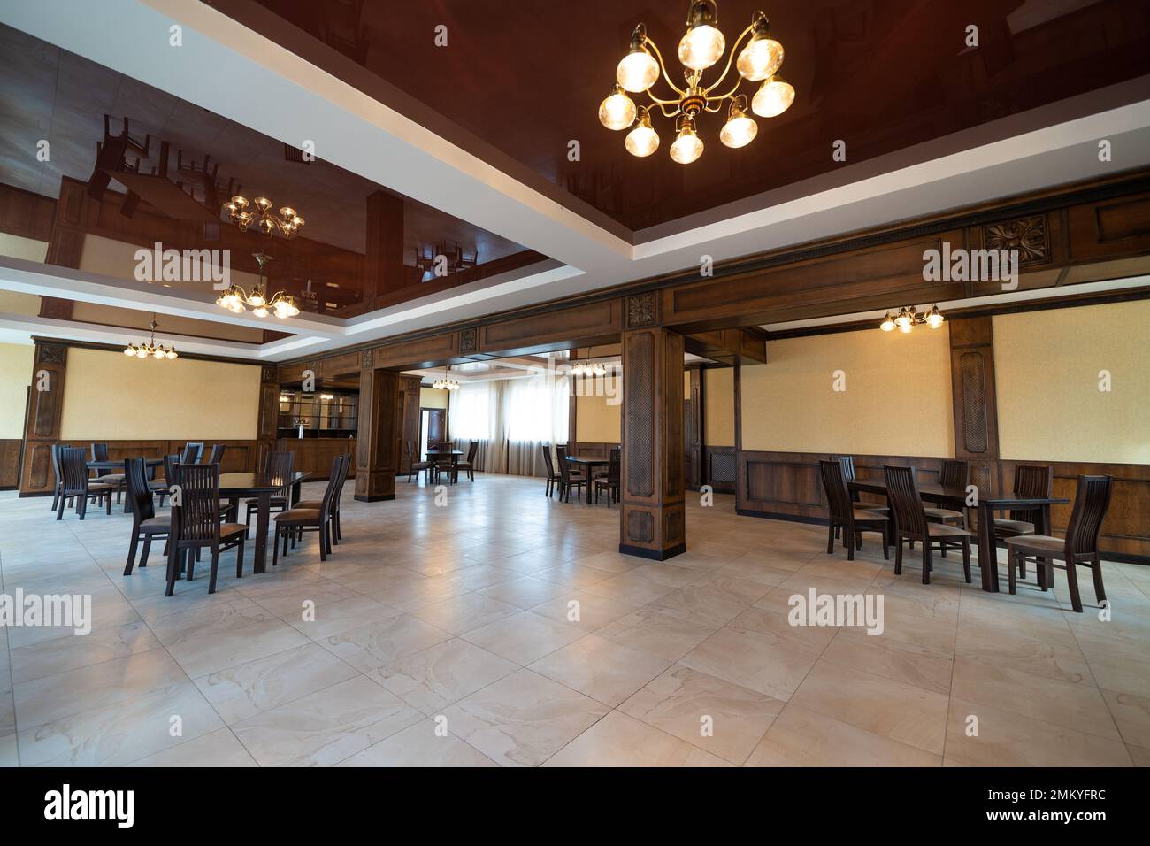 spacious interior of modern empty large restaurant with tables and ...