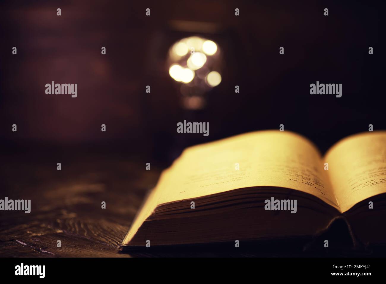 Book on a wooden table background with copy space. Historical ...