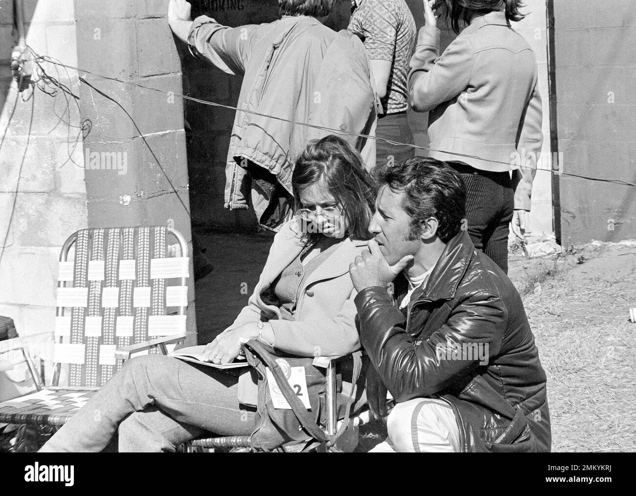 Race driver Mario Andretti talks with Catherine Ickx, wife of his co ...