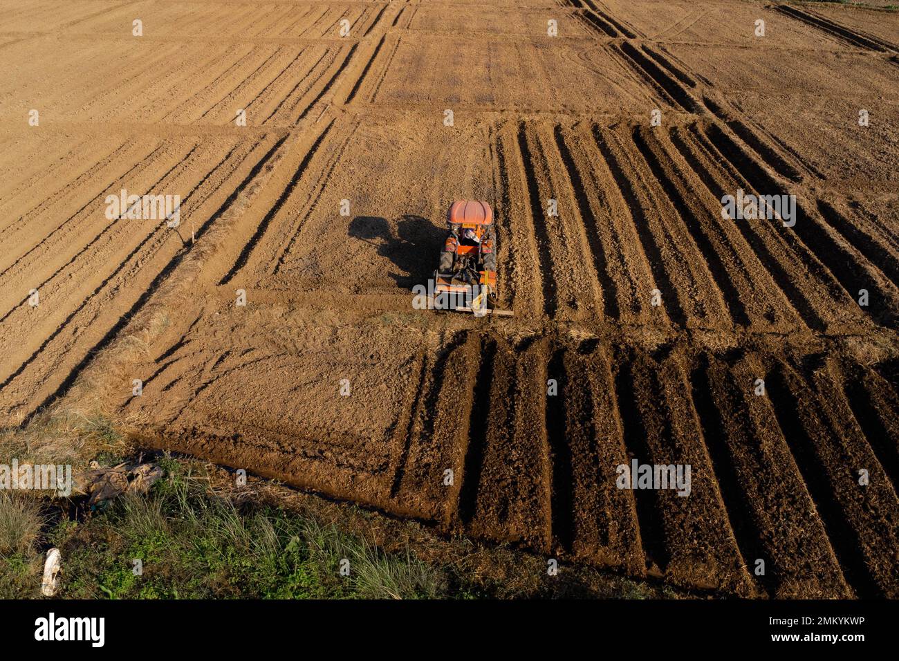 Aerial view of fields and agricultural parcels. Farmer in tractor ...
