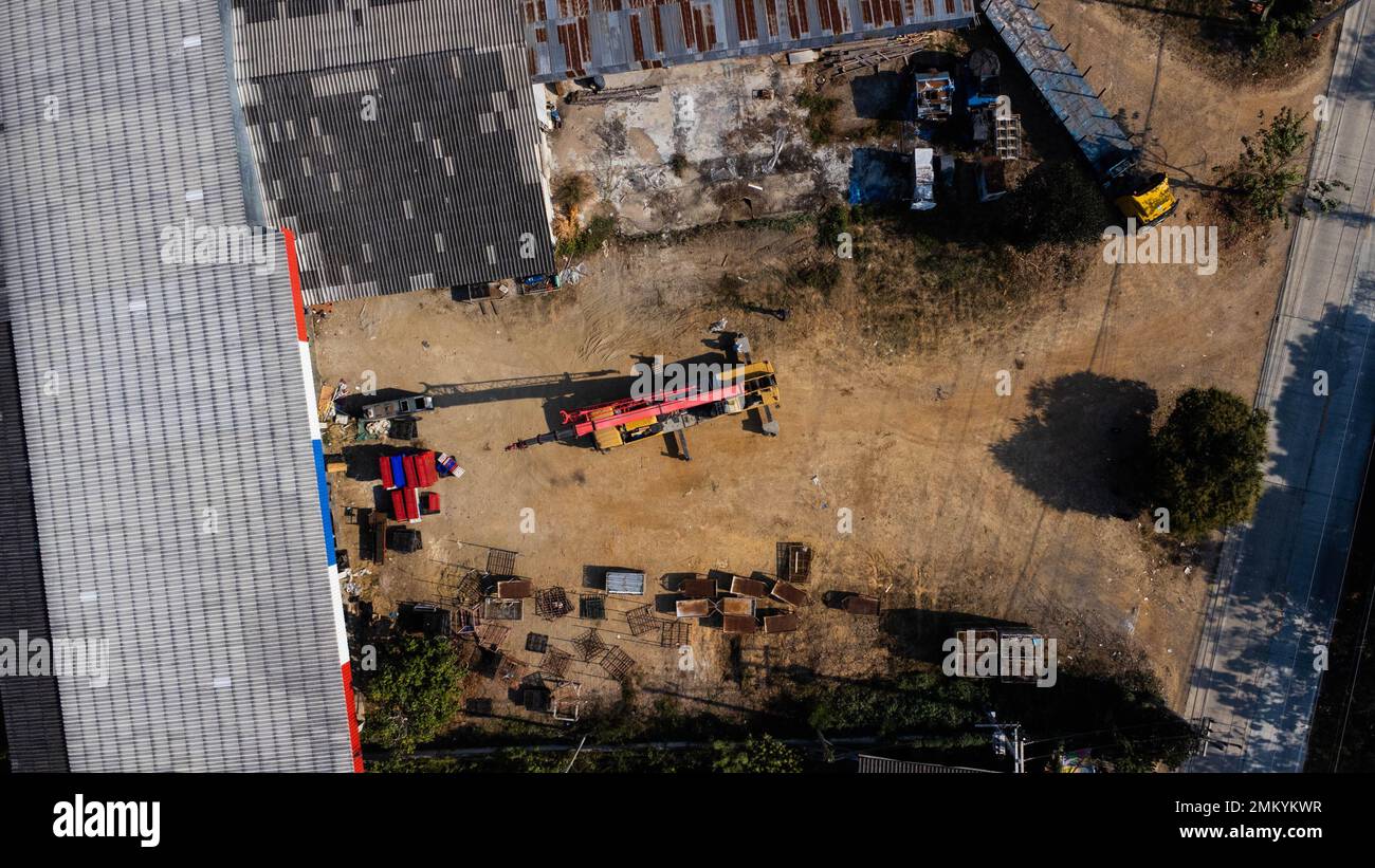 Mobile crane stands waiting to lift steel at a warehouse. Crane ...