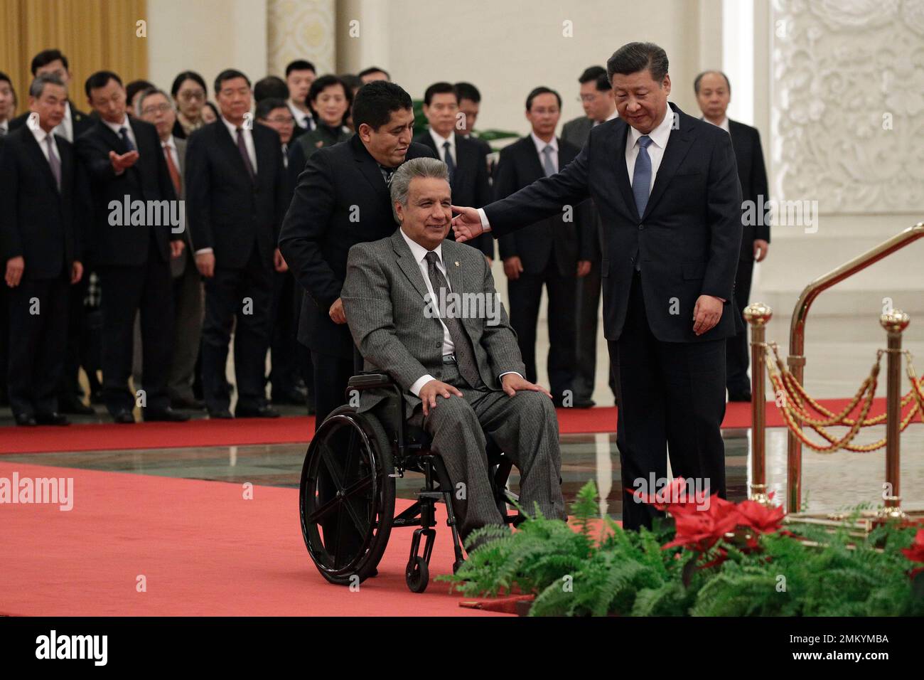 Chinese President Xi Jinping, right, lends a hand to Ecuador's ...